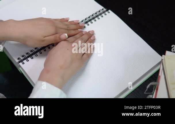 Hand touches the description in Braille. Braille is a tactile writing ...