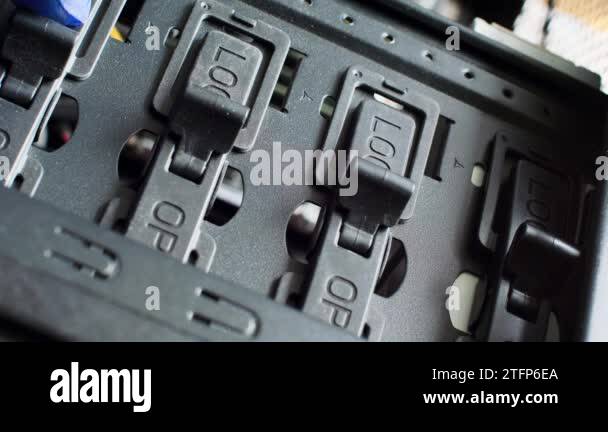 A blue gloved hand opens the switches from the Lock to the Open ...