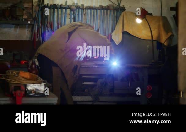 A man welds plates for body armor from springs. homemade armor plate ...