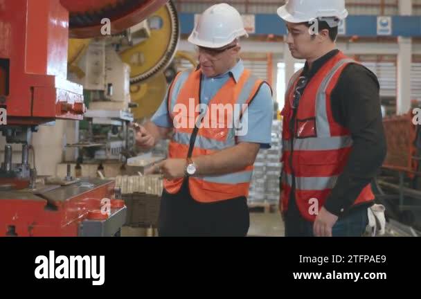 Two engineers talking together in roof steel metal manufacturing ...