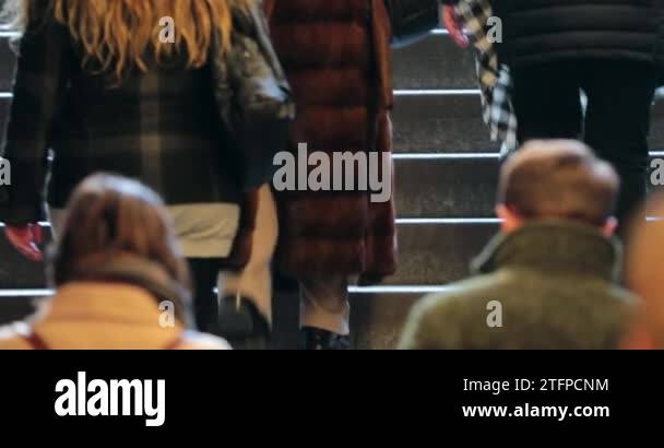 Crowd of people walking up the stairs to the surface. People exiting ...