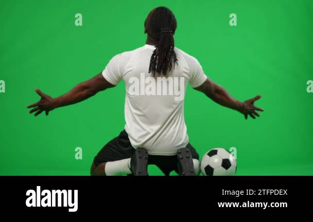 Back view triumphing African American sportsman sitting on knees at ...