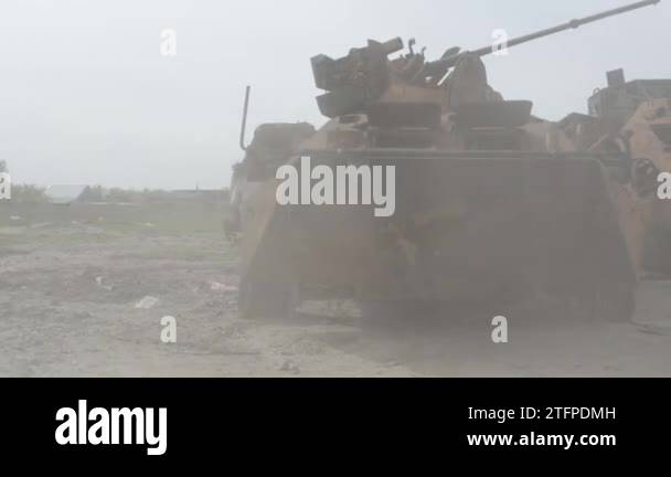 Destroyed military convoy. Burnt combat vehicles. Rusty tech ...