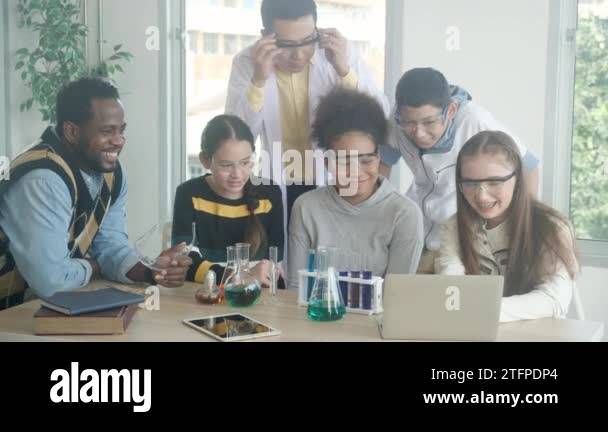 Young teacher teaching group student about science and explaining ...