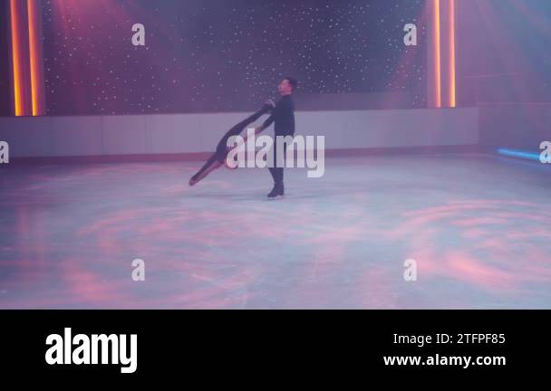 Figure skaters pair on ice performs stationary rotational support ...