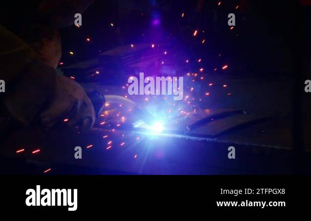 close-up, A man welds plates for body armor from springs. homemade ...