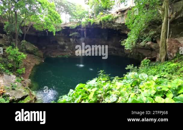 huge cave with waterfall and crystal clear water. cenotes in Mexico ...