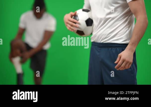 Unrecognizable Caucasian sportsman bouncing football ball standing on ...