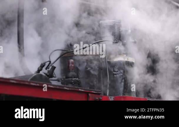 Smoke covering the train. Retro steam locomotive departs from railway ...