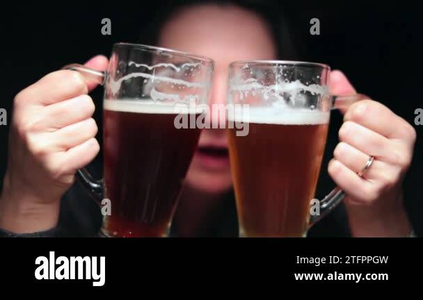 Woman acting silly celebrating with craft beers toasting herself ...