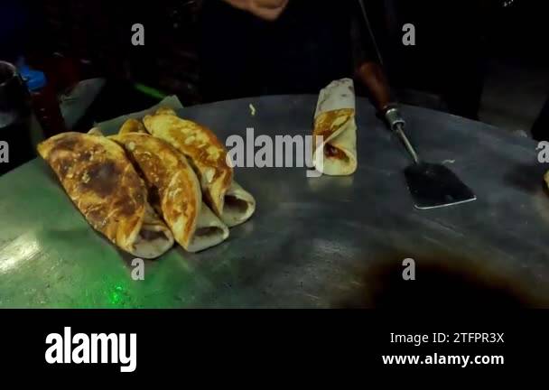 Wrapping naan tikki roll in paper, Spicy wrap pakistani and indian ...