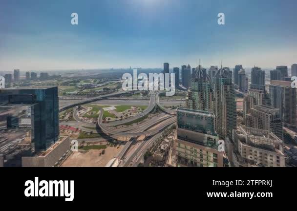 Dubai marina and JLT skyscrapers along Sheikh Zayed Road aerial all day ...