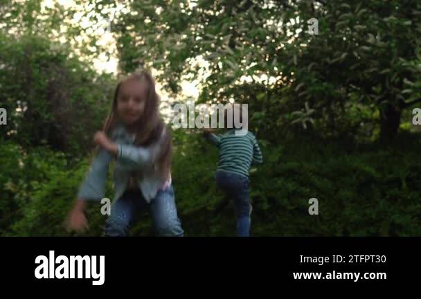 Friends Excited young children siblings Dancing have fun on grass ...