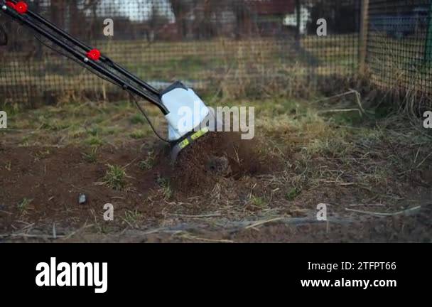 Man farmer working in field ploughing the land with a plough on a farm ...