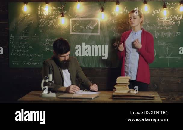 Teacher and college student in classroom. School mathematics lessons. Teacher couple. Knowledge ...