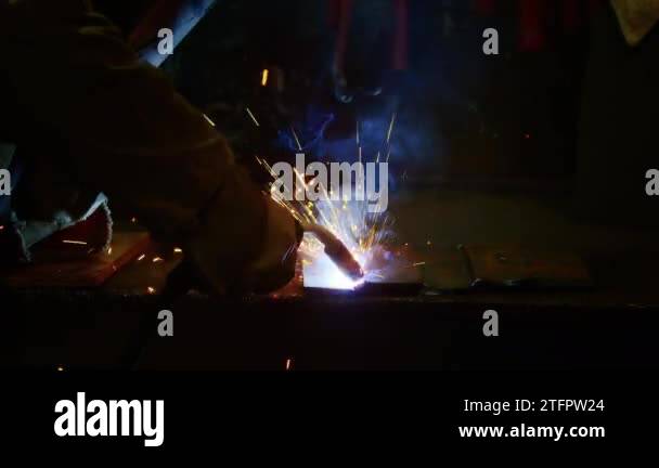 close-up, A man welds plates for body armor from springs. homemade ...