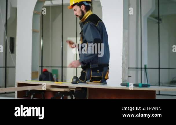 Attractive and excited constructor worker at construction site working ...