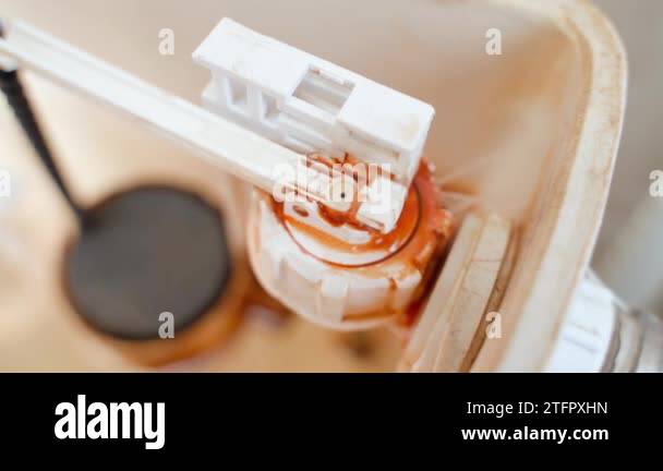 Cracked water intake valve in the toilet bowl. Leaking toilet. Float mechanism failure Stock ...