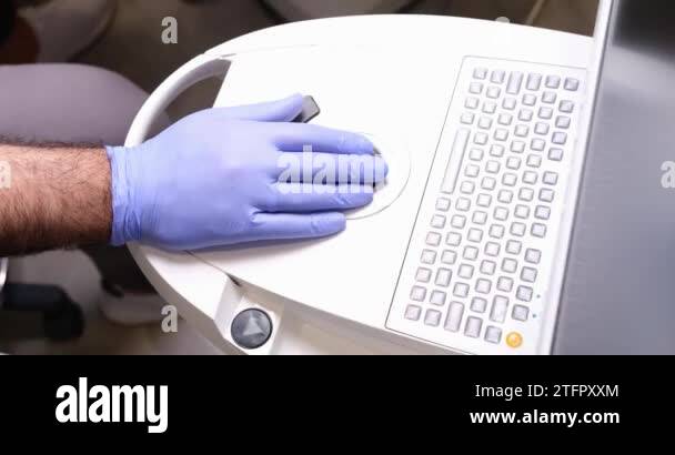 Doctor hand is working on keyboard of medical device. Control panel ...