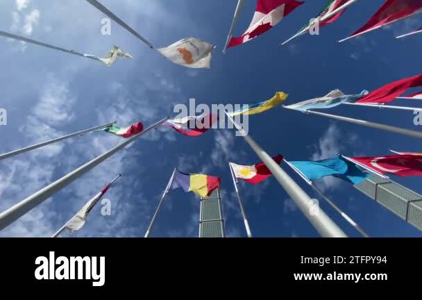 Flags of the World waving in the wind on a background blue sky and ...