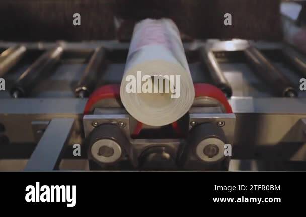 A roll of wallpaper on a conveyor line. Roll of wallpaper. Conveyor ...