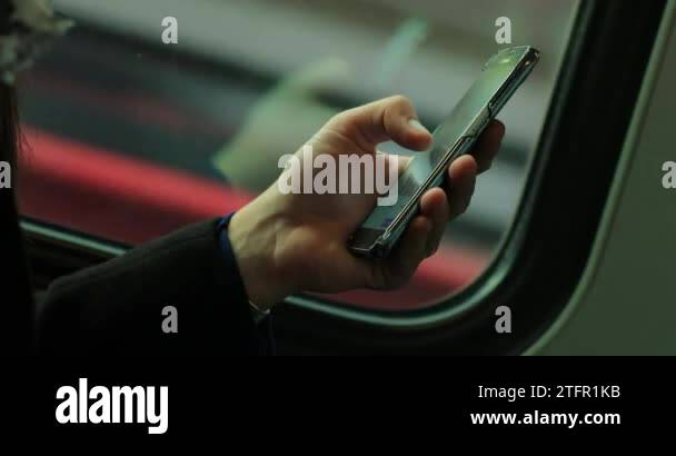 Person hands checking cellphone on a moving train in motion. Hands ...