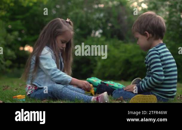 Friends selfie. Excited young children playing lying on grass meadow ...