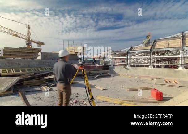 Construction worker using theodolite surveying optical instrument ...