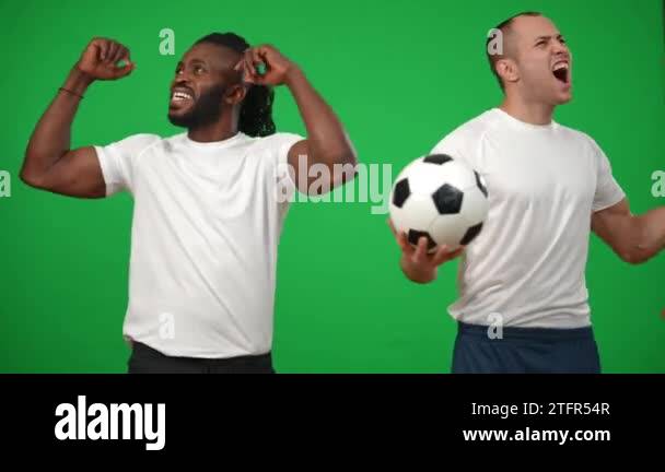 Inspired satisfied African American and Caucasian men cheering at green ...