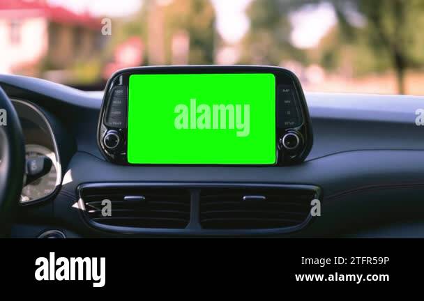 Green navigation screen on the dashboard from inside a modern new car ...