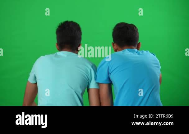 Back view two inspired Middle Eastern young men talking gesturing ...