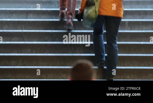 Crowd of people walking up the stairs to the surface. People exiting ...