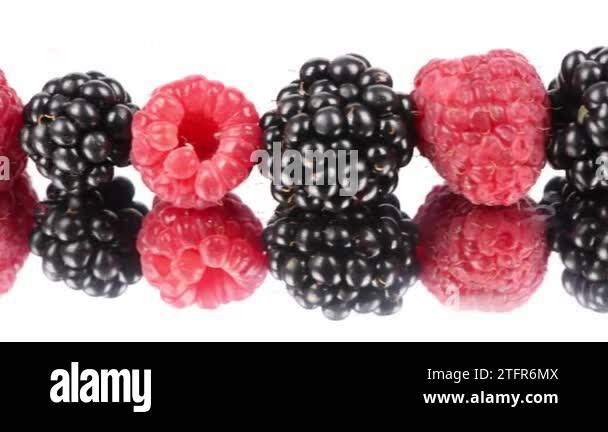 Raspberries alternate with blackberries. Movement from left to right on silver mirror. Side view ...