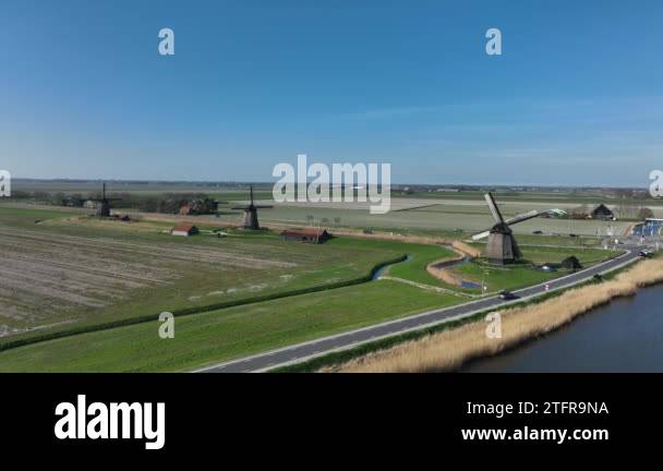 Historic dutch windmills in a farm and grass field landscape in The ...