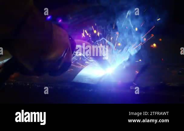 close-up, A man welds plates for body armor from springs. homemade ...