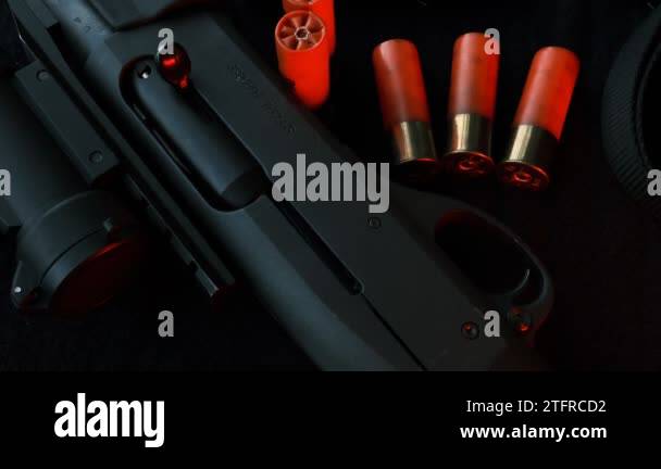 Weapon on black cloth: flashlight, knife, rifle, shells,top view. Top view of knife rifle shells ...