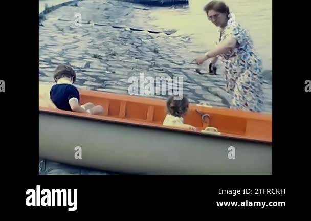 milan, italy june 18 1970:woman with children on a lake shore boat from ...