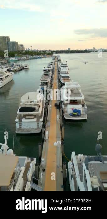 Vertical aerial drone flyover yachts at perimeter dock Miami Haulover ...