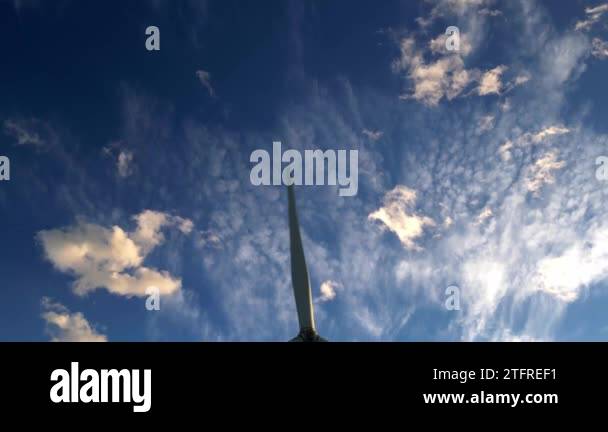 Wind turbines during sunrise. Wind farm generating green energy in the ...
