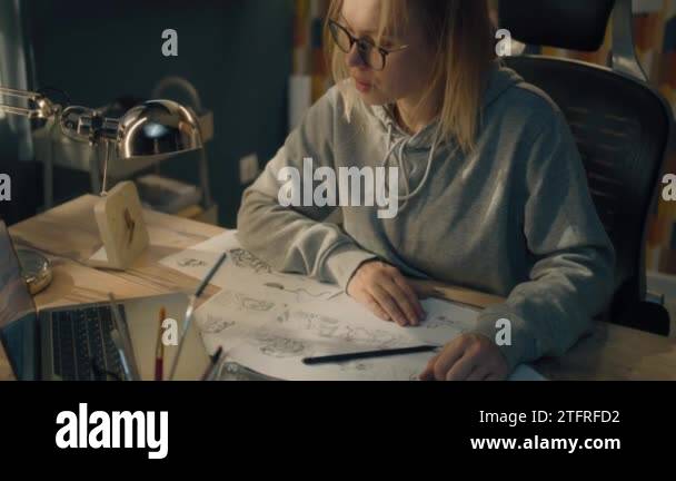 Female animator finishes her sketches for the storyboard. Shuts down ...