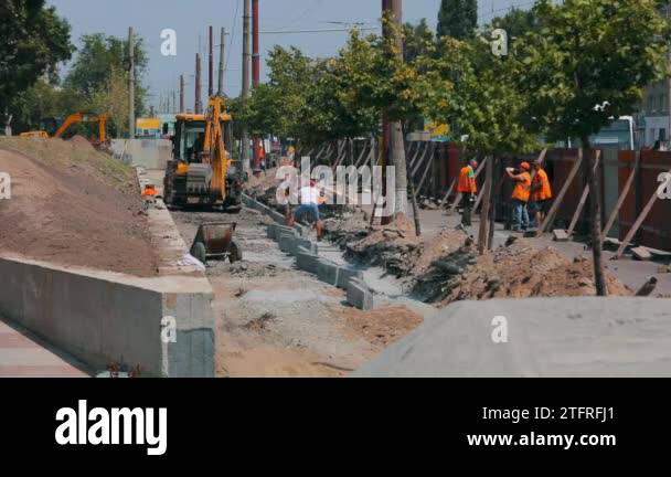 Construction of a footpath. The tractor performs construction work. The ...