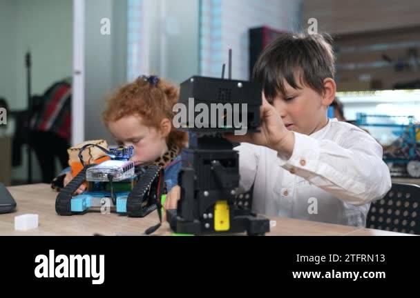 Enthusiastic elementary school children playing and constructing ...