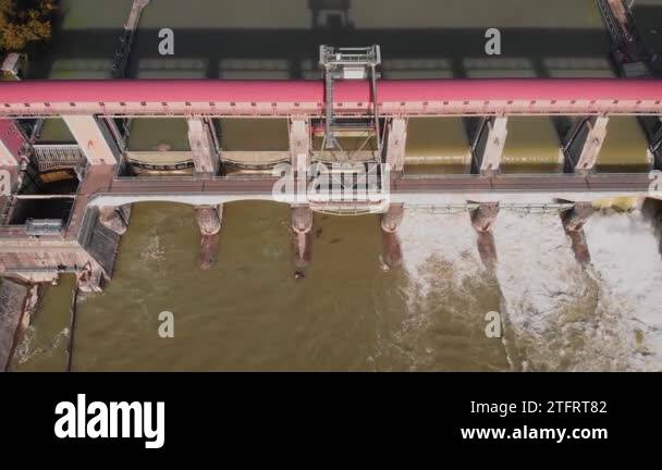 Powerful water stream flowing through opened gates on river dam. Large ...