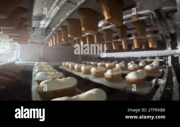 Ice cream production process. Making ice cream in a cup at the factory ...