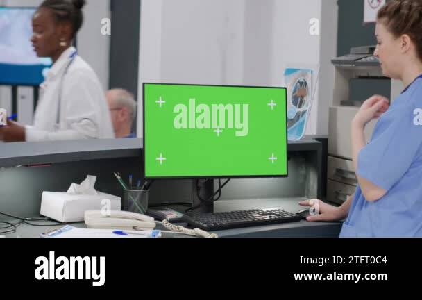 Medical nurse working with greenscreen on computer at hospital ...