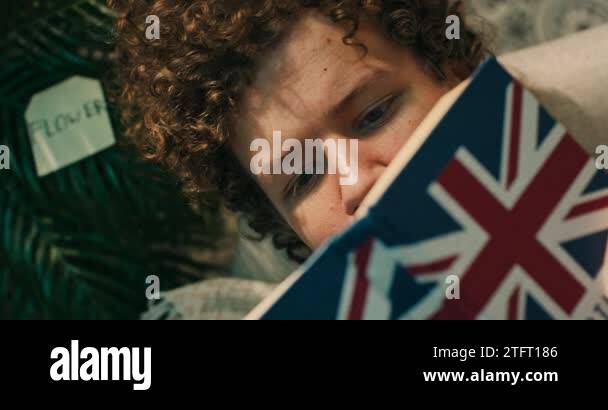 Eyes of a teenager reading an English dictionary textbook. Young boy is ...