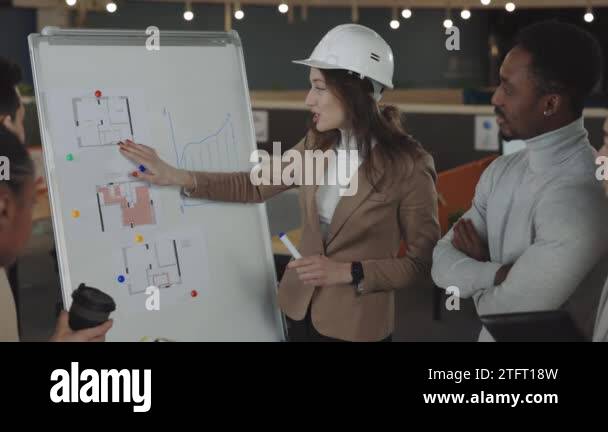 Young female architect moving hand over design of building on flip ...