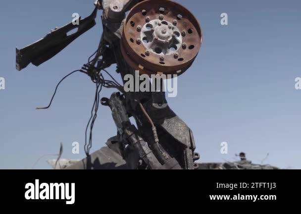 Burnt military equipment after a missile attack. Abandoned rusty military equipment. City of ...