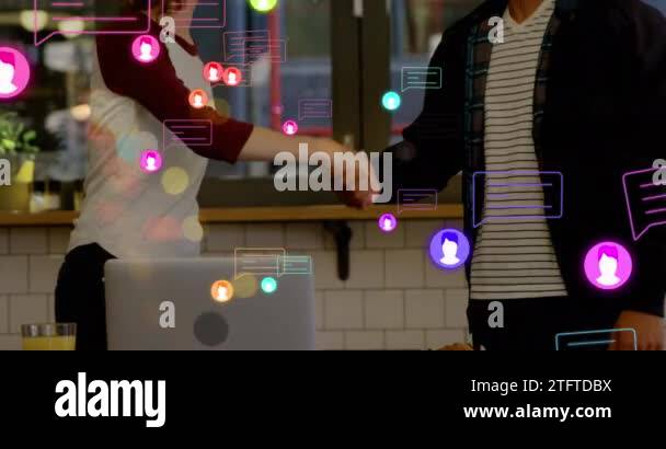 Animation of social media icons over diverse business people shaking ...