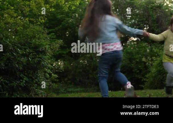 Friends Excited young children siblings Dancing have fun on grass ...